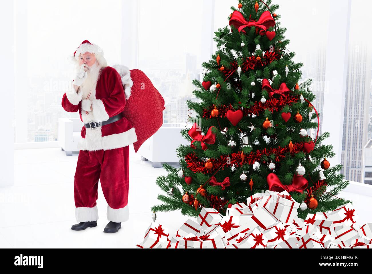 Santa claus with finger on lips standing near christmas tree Stock ...