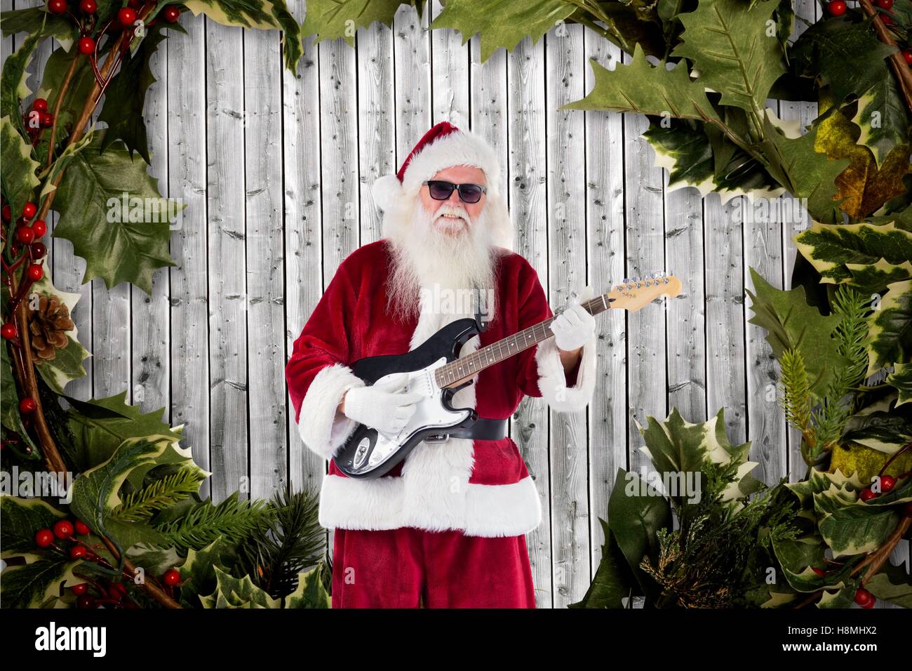 Santa claus playing guitar against digitally generated background Stock ...