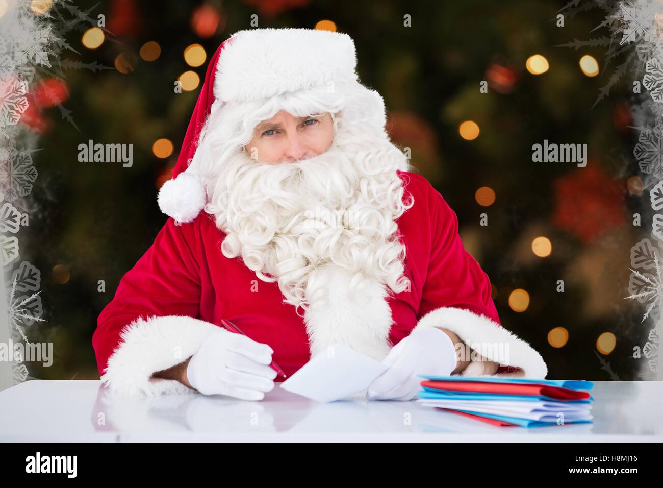 Santa claus sitting while making a check list Stock Photo - Alamy
