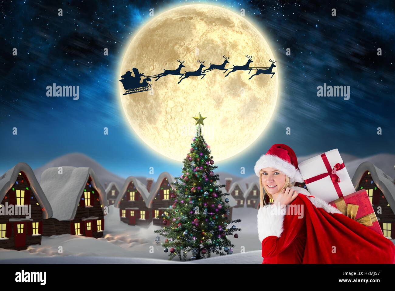 Female santa claus standing against digitally generated background ...