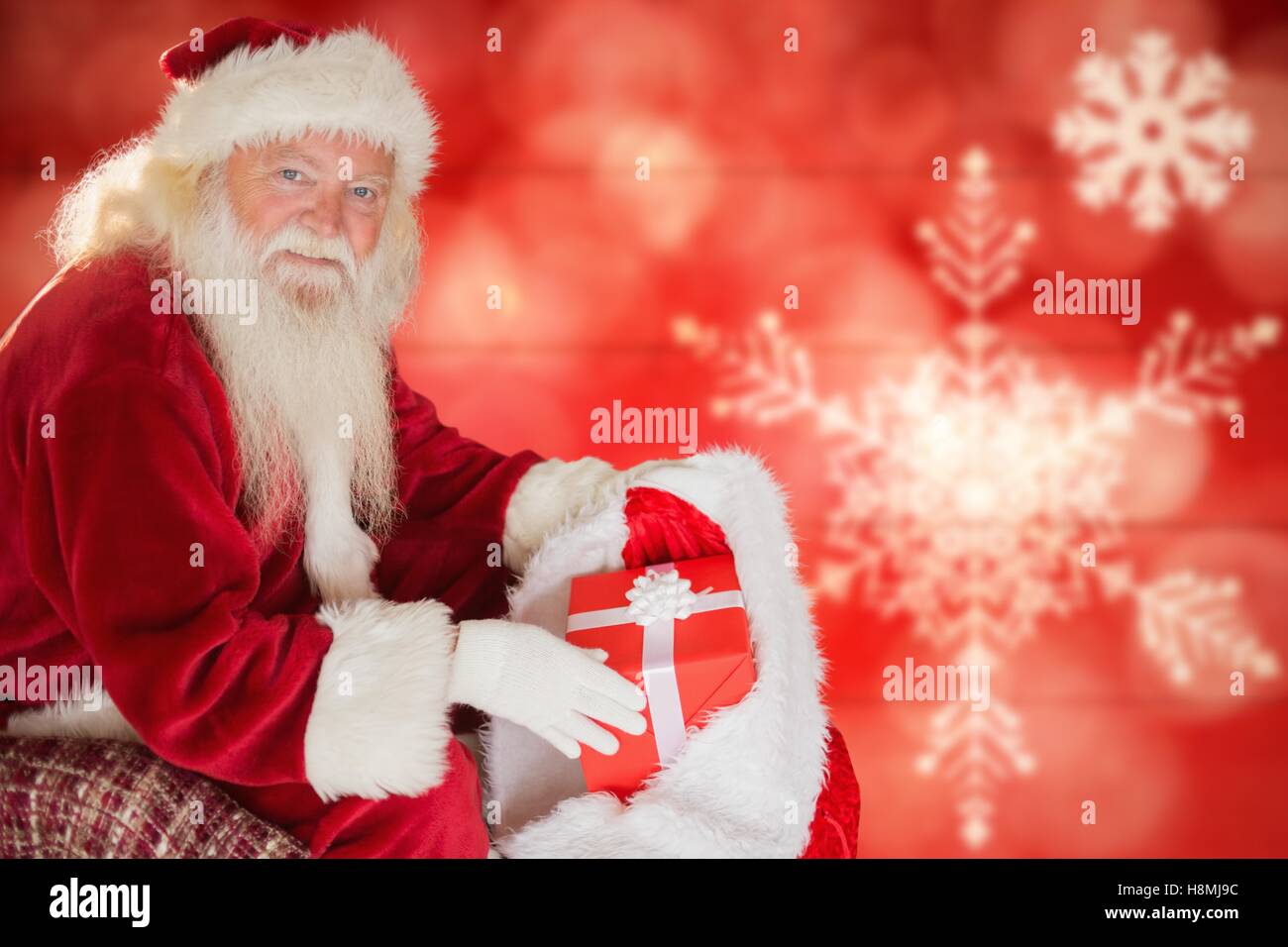 Portrait of santa claus removing gift from sack Stock Photo - Alamy