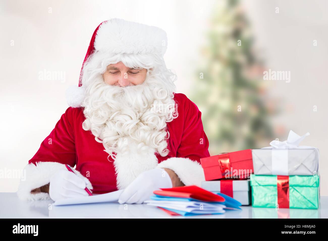 Santa claus writing a letter Stock Photo - Alamy