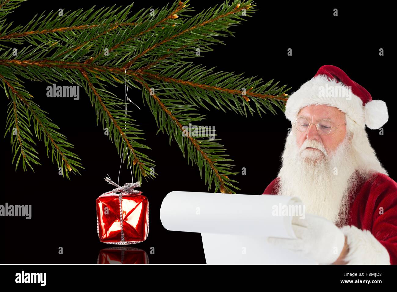 Santa claus preparing checklist during christmas time Stock Photo - Alamy