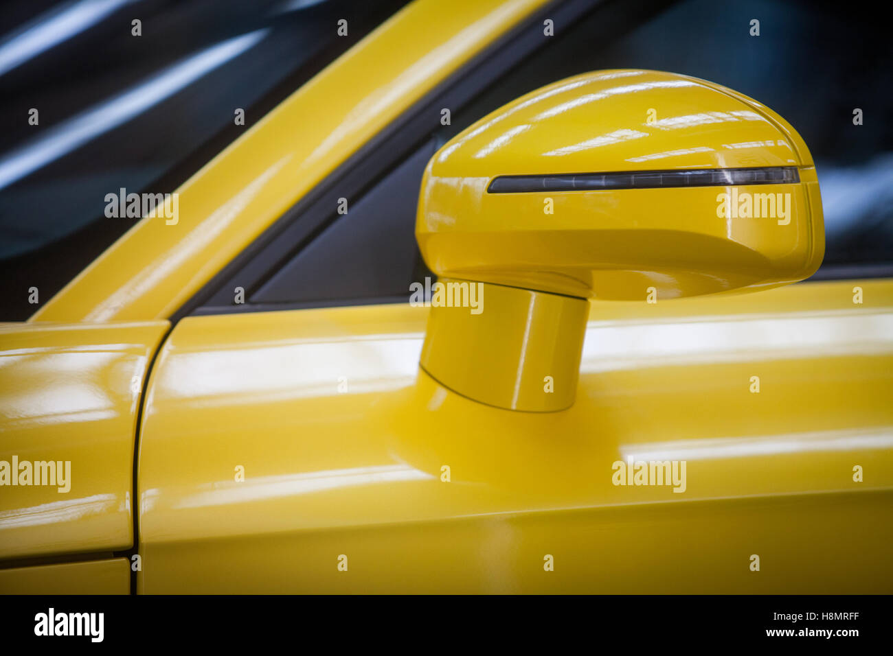 Color image of a yellow modern car side mirror Stock Photo - Alamy