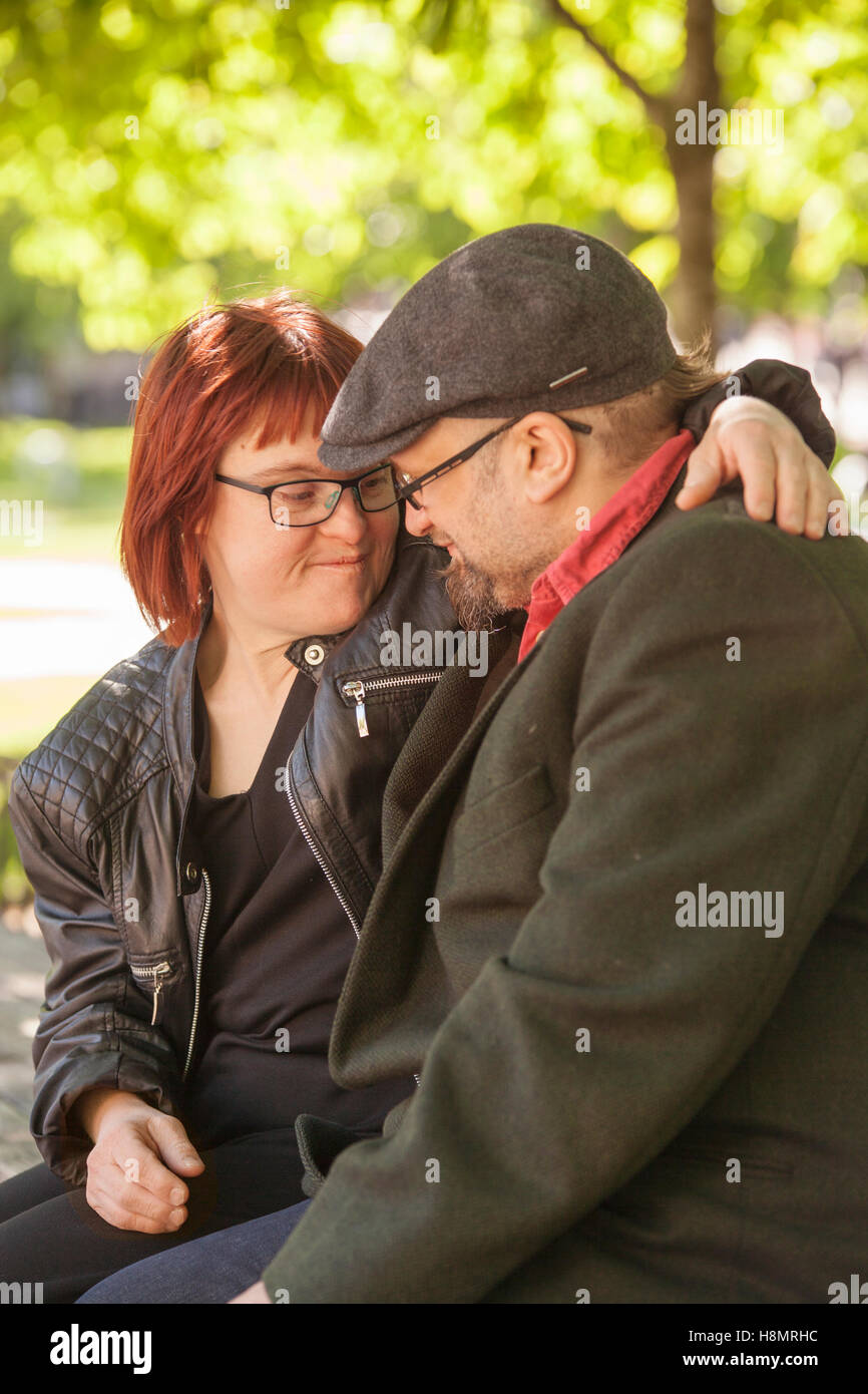 Two females sitting down hugging hi-res stock photography and images ...