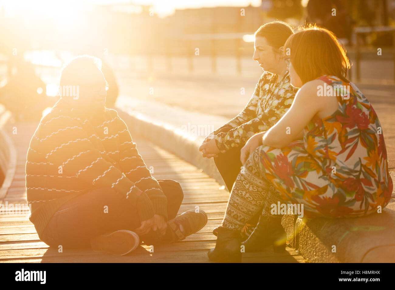 Sitting down outside together hi-res stock photography and images - Alamy