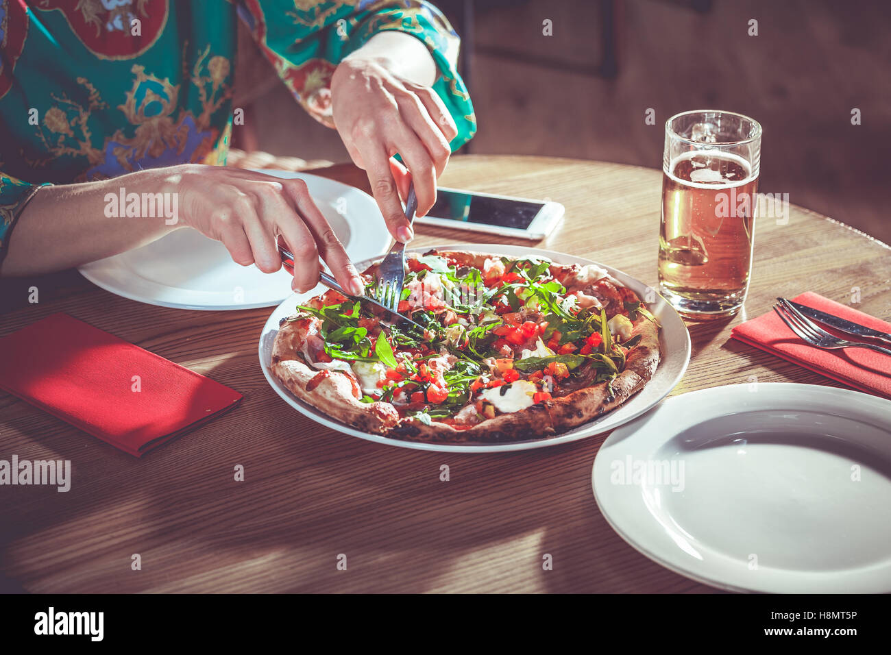 Woman eating at restaurant Stock Photo - Alamy