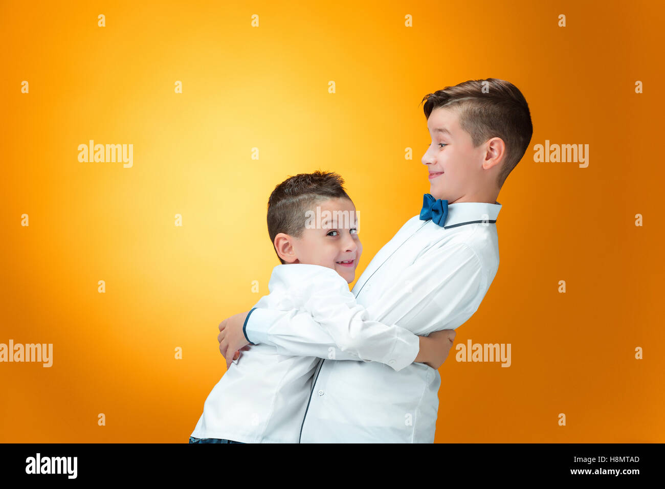 Happy children playfully fighting Stock Photo - Alamy