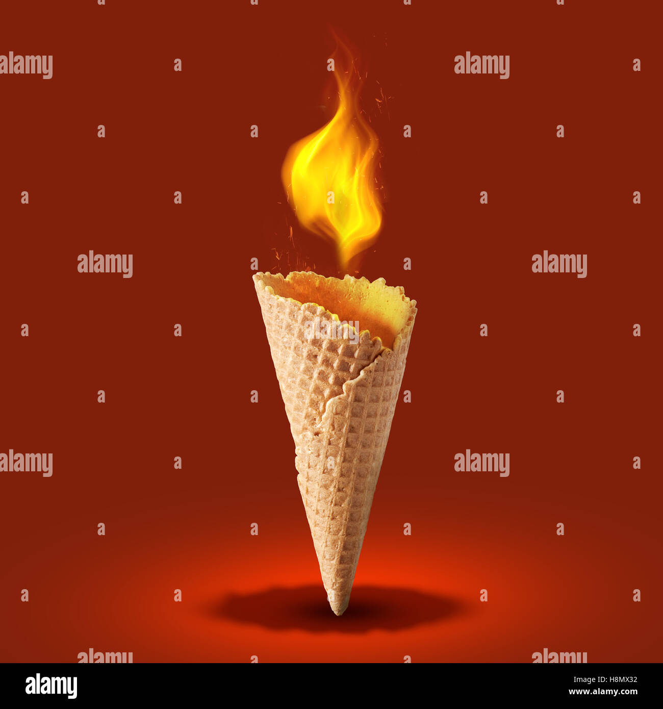 wafer cone with fire on color background Stock Photo - Alamy