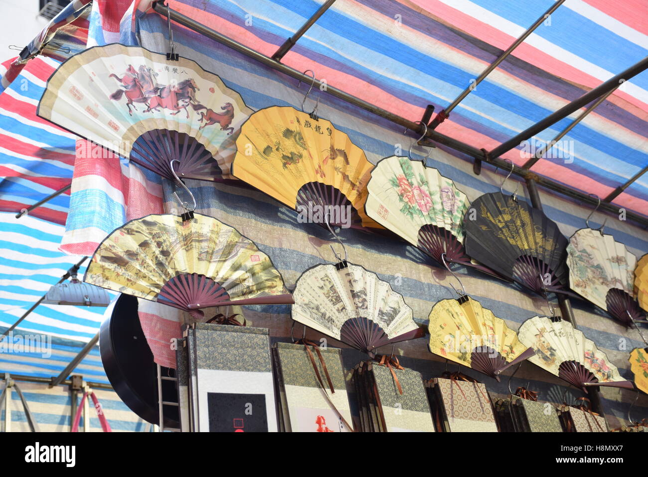 Typical colorful chinese fans hanging in a market stall Stock Photo - Alamy