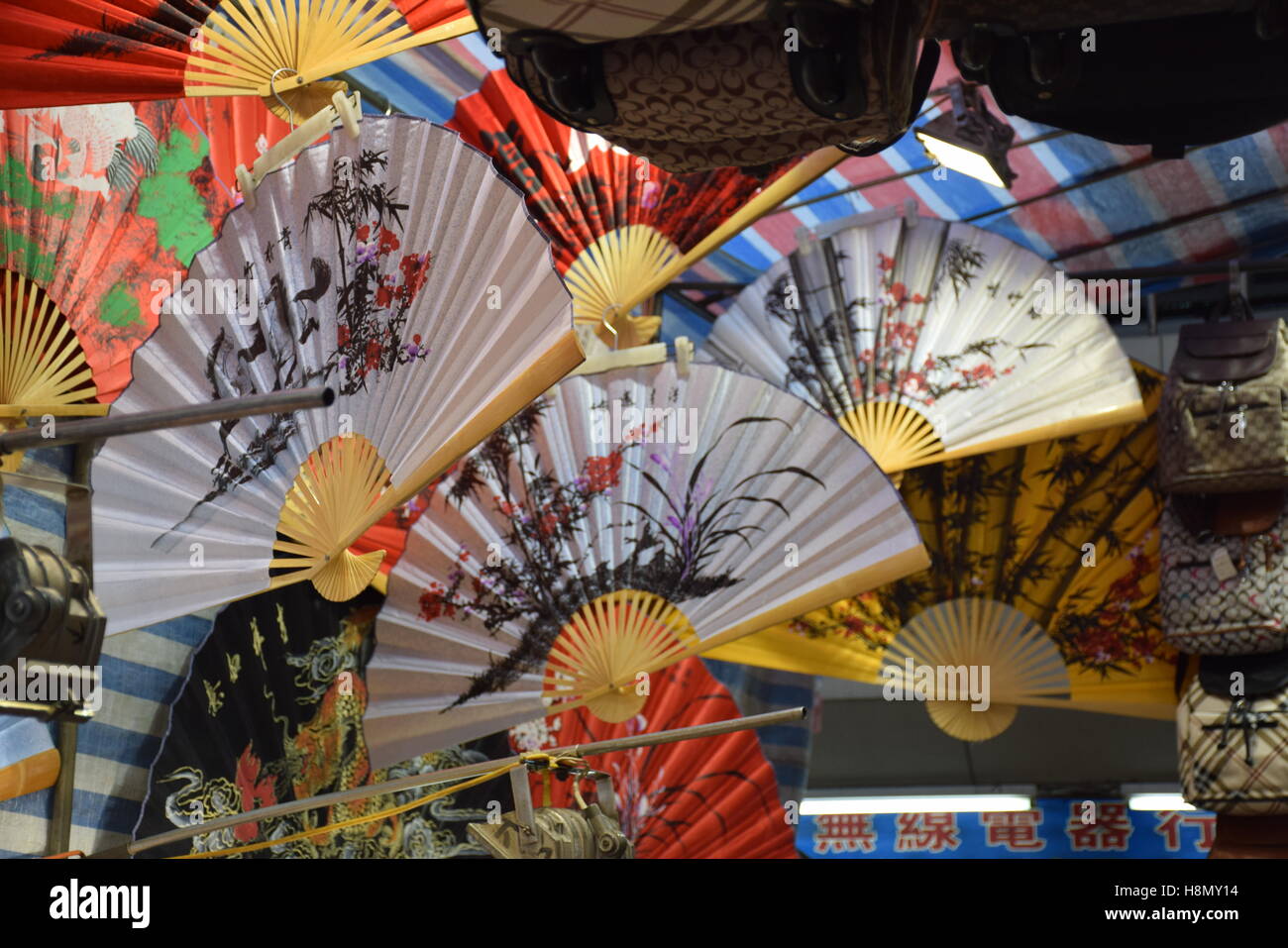 Several colorful chinese fans hanging in a stall in Hong Kong Stock ...