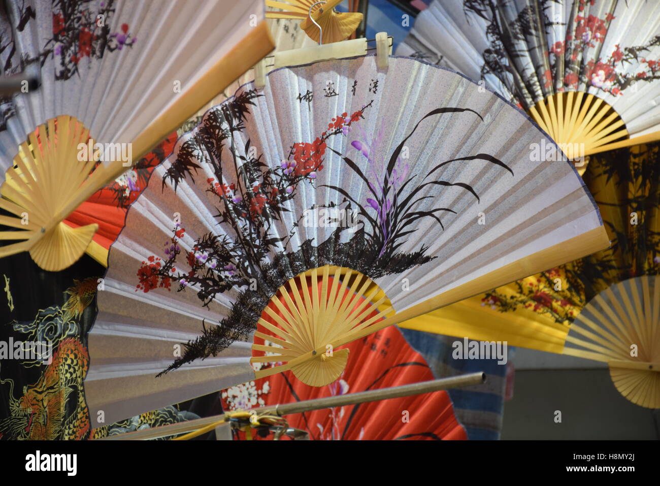 Typical colorful chinese fan hanging in a stall Stock Photo - Alamy