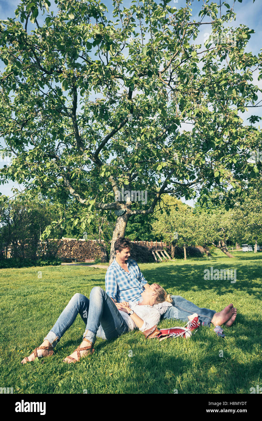 Couple leaning on tree hi-res stock photography and images - Alamy