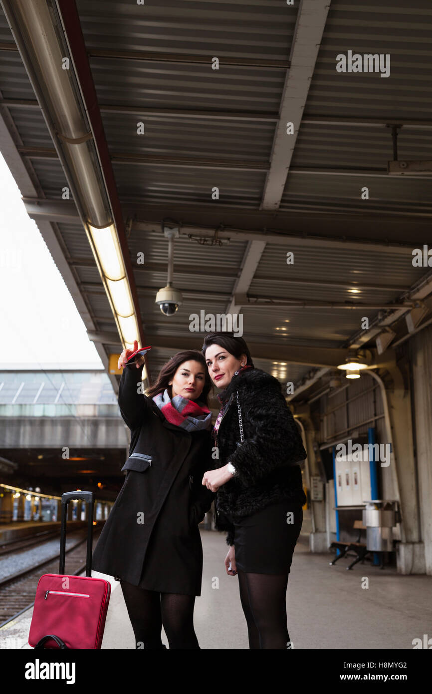 Women talking while waiting for train Stock Photo - Alamy