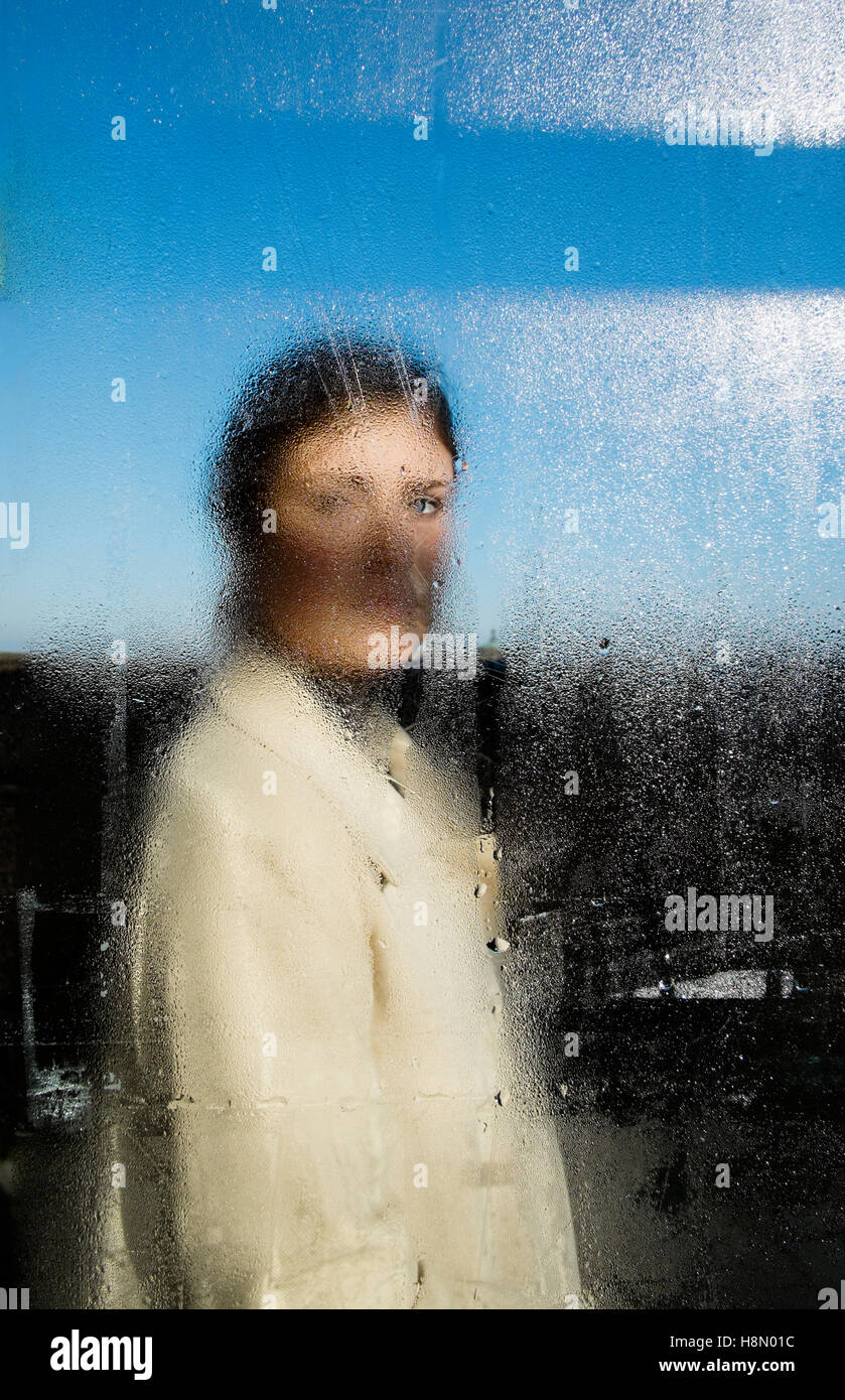 Woman behind wet window hi-res stock photography and images - Alamy