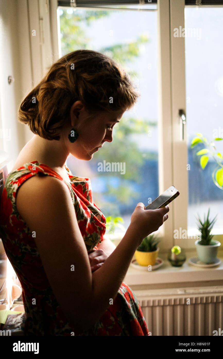 Young woman texting on smart phone Stock Photo - Alamy