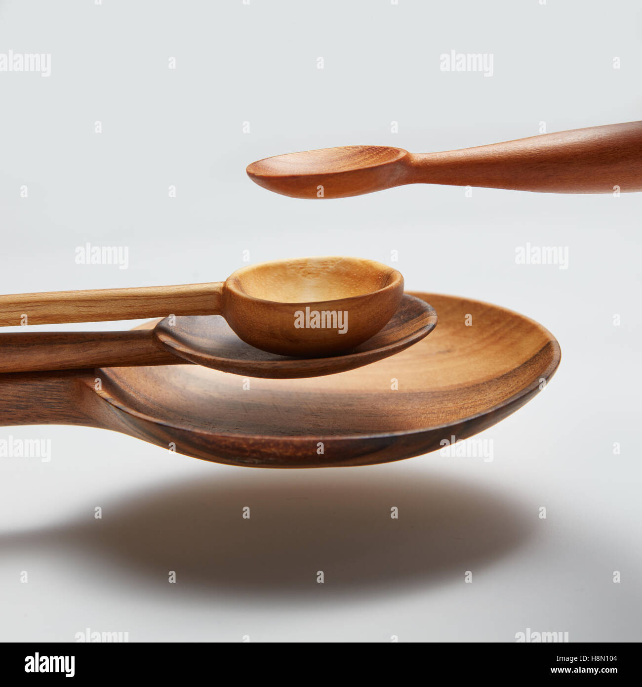 different wood spoon isolated in air Stock Photo - Alamy