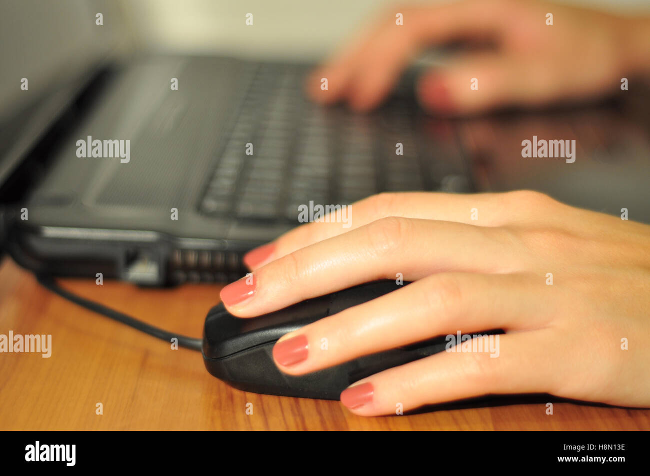 Woman typing on laptop keyboard Stock Photo - Alamy