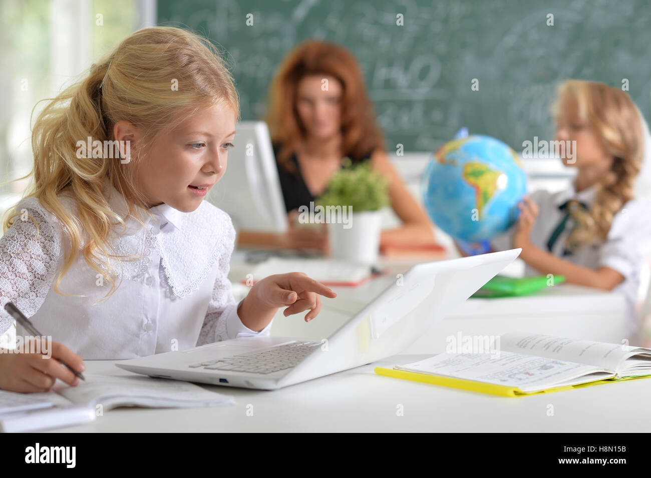 teacher with two girls Stock Photo - Alamy
