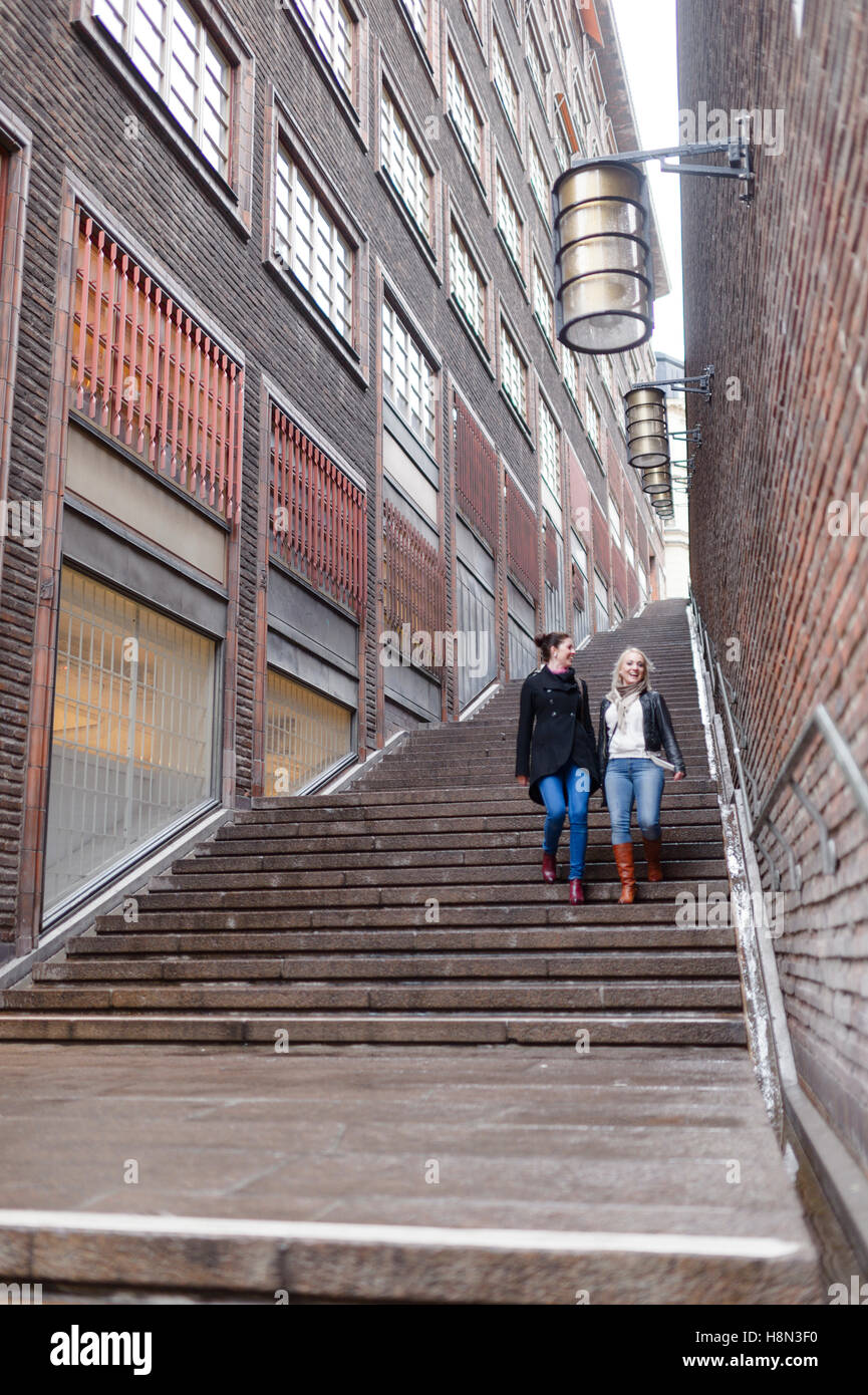 Woman descending stairs hi-res stock photography and images - Alamy
