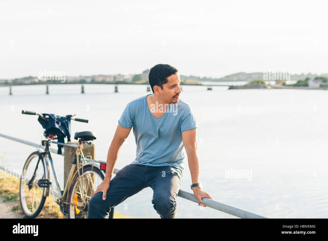 Man sitting on railing hi-res stock photography and images - Alamy
