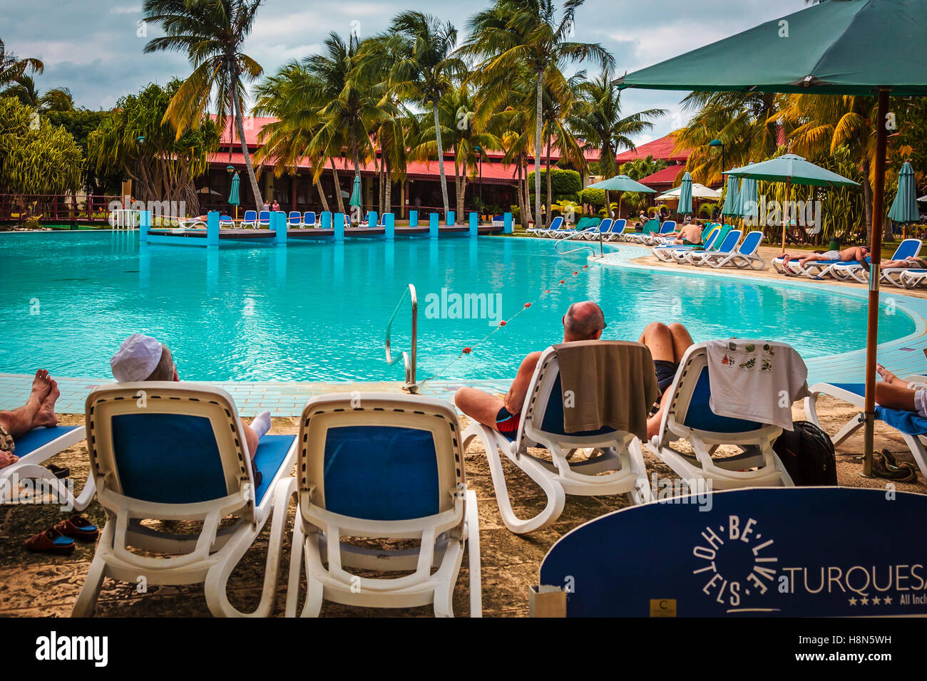 Hotel residents relaxing around the pool at a holiday resort in Cuba ...