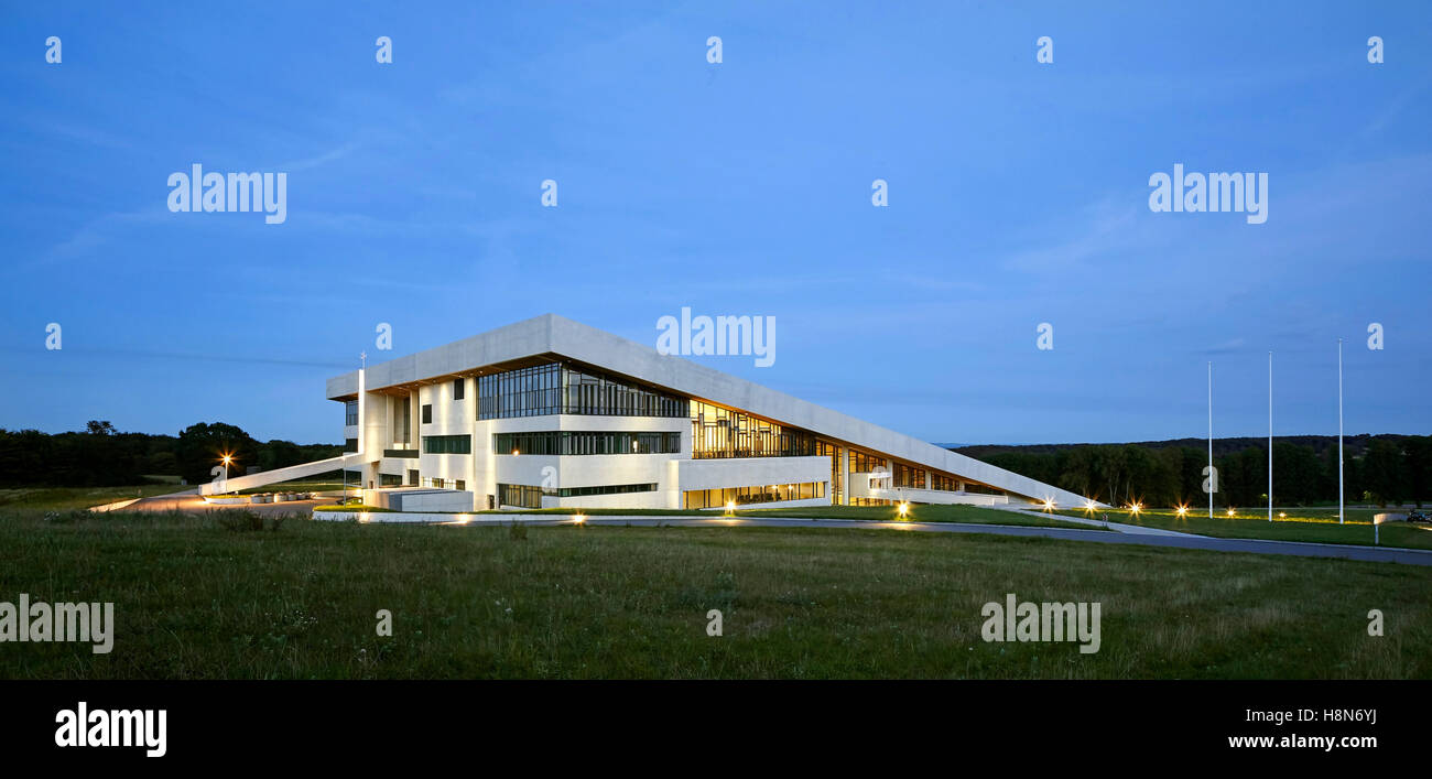Distant side elevation at dusk. Moesgaard Museum, Aarhus, Denmark ...