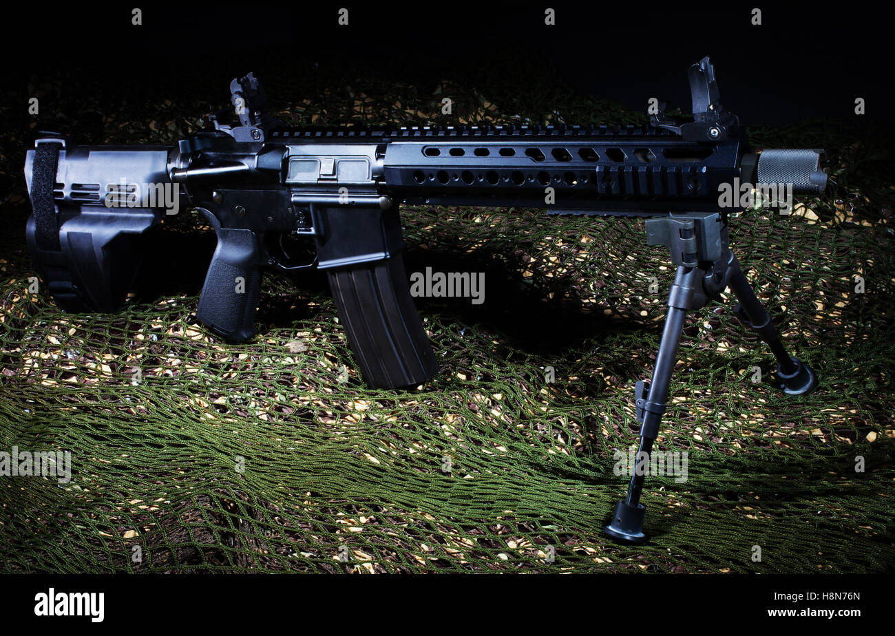 Assault rifle that is handgun length on green neeting Stock Photo - Alamy