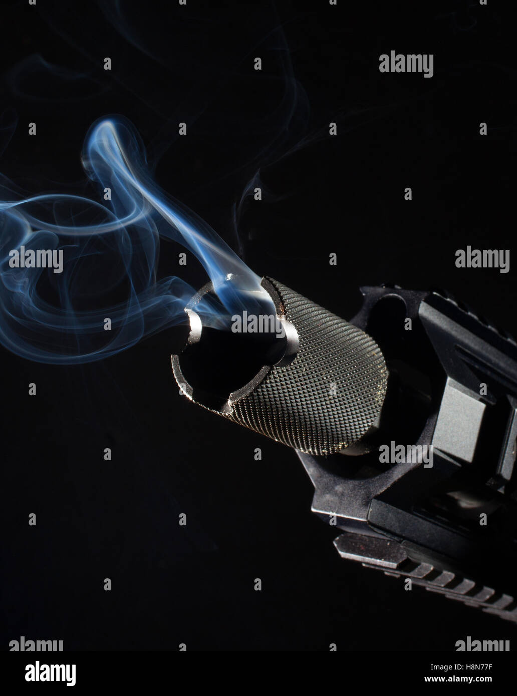 Firearm that has blue and white smoke coming from its barrel Stock ...