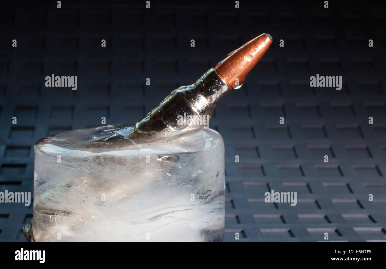 Drop of water about to fall from a bullet trapped in ice Stock Photo ...