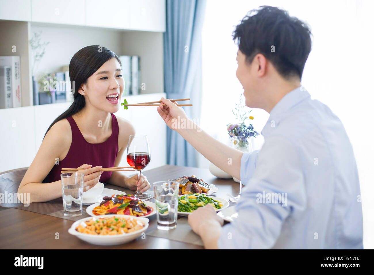 Romantic young Chinese couple dining at home Stock Photo - Alamy