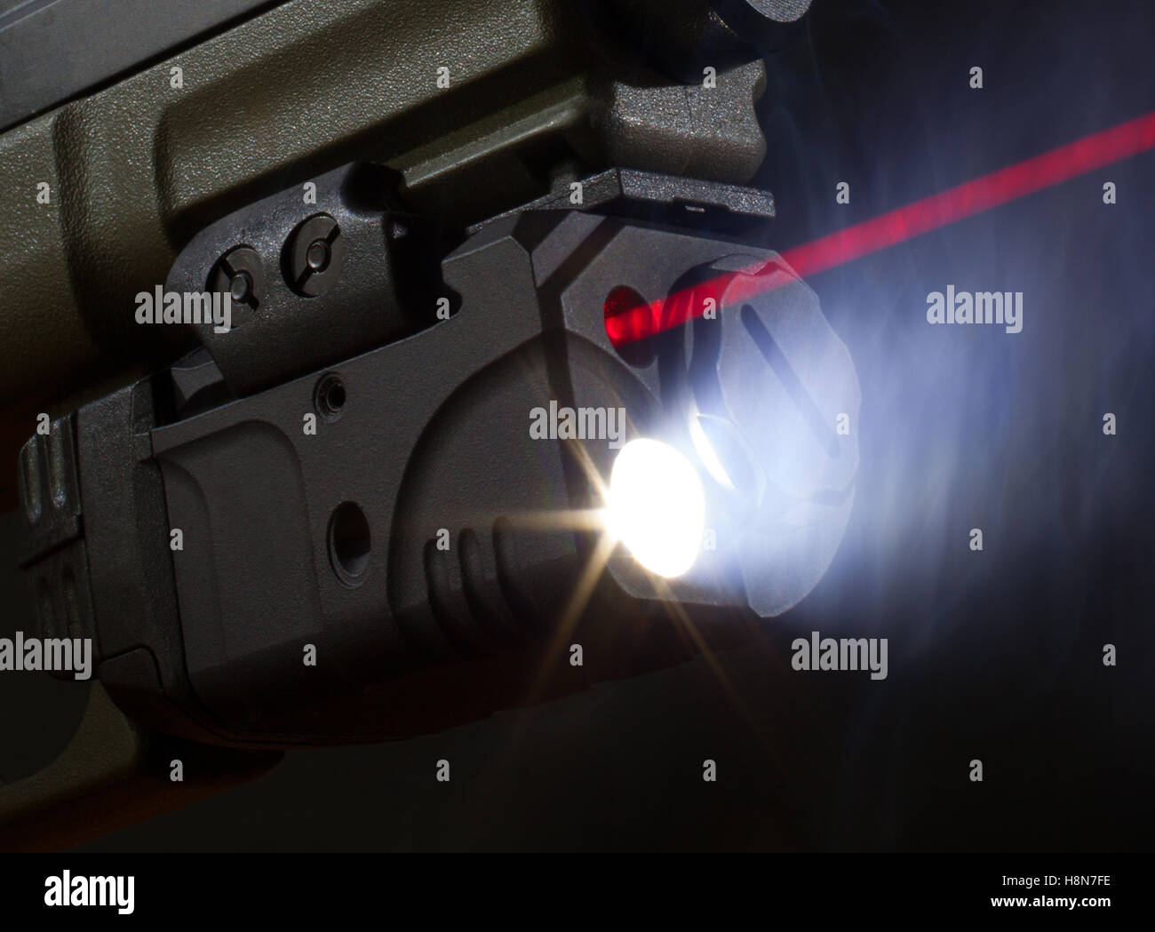 Laser and flashlight mounted on the bottom of a pistol Stock Photo - Alamy