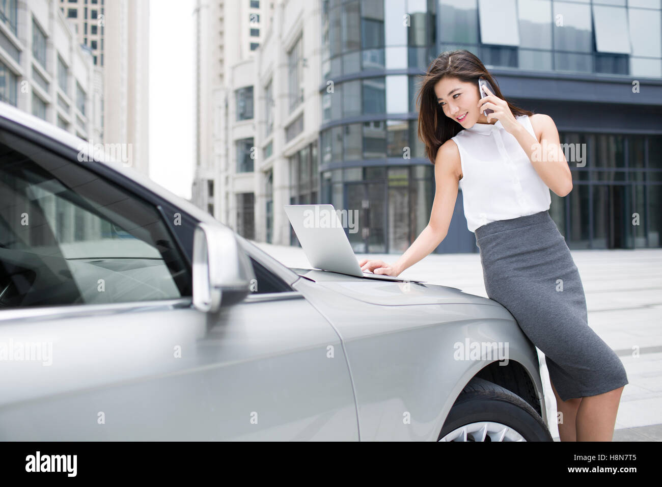 Confident Chinese businesswoman talking on cell phone Stock Photo - Alamy