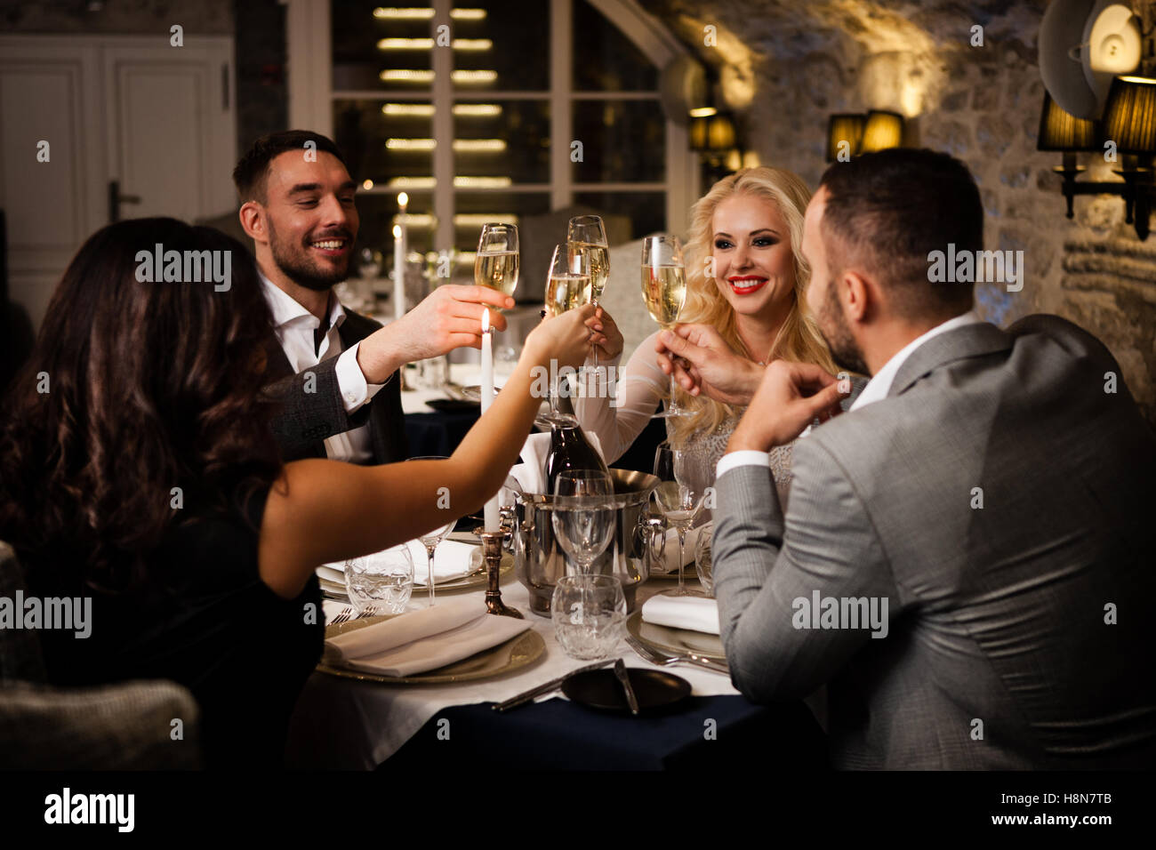 Four friends celebrating Stock Photo - Alamy