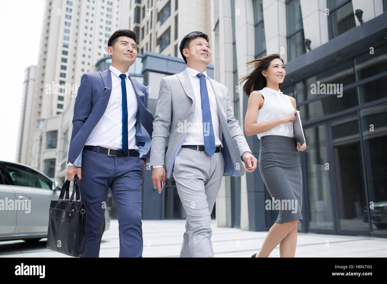 Confident Chinese business team on the move Stock Photo - Alamy