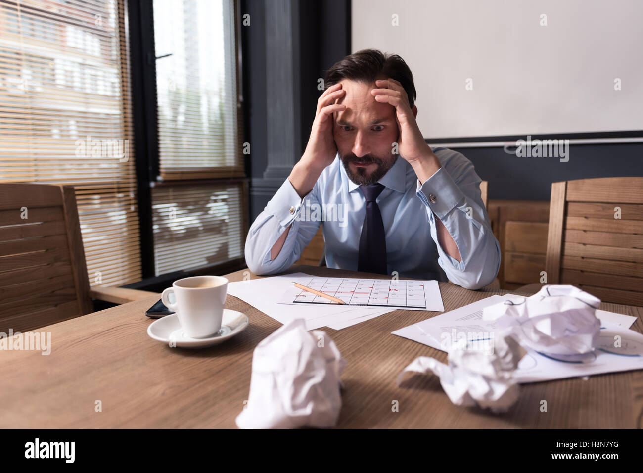 Depressed tired man holding his head Stock Photo - Alamy