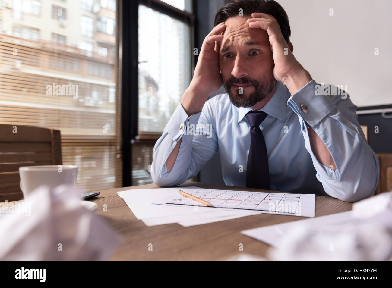 Sad cheerless man looking for a solution Stock Photo - Alamy
