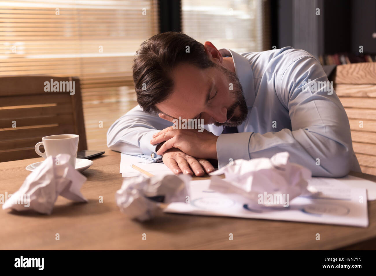 Handsome tired man sleeping at the workplace Stock Photo - Alamy