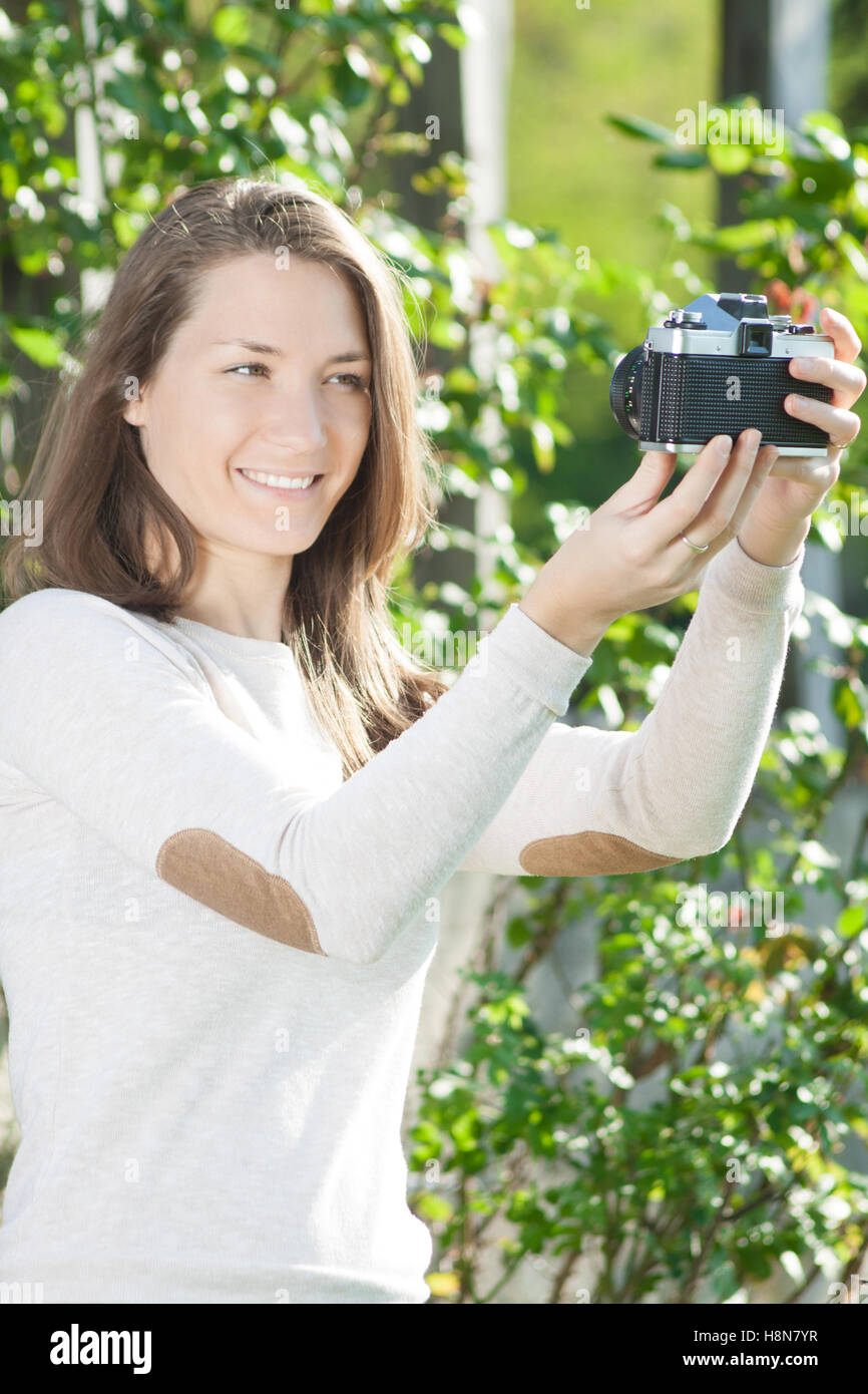 Young woman holding retro vintage camera hi-res stock photography and ...