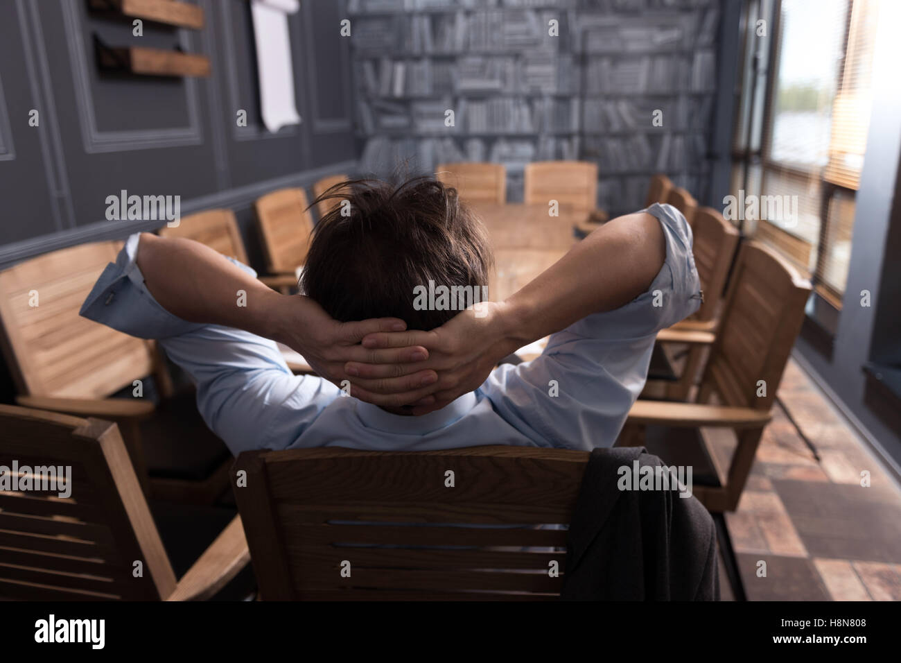 Calm relaxed man reclining in a chair Stock Photo - Alamy