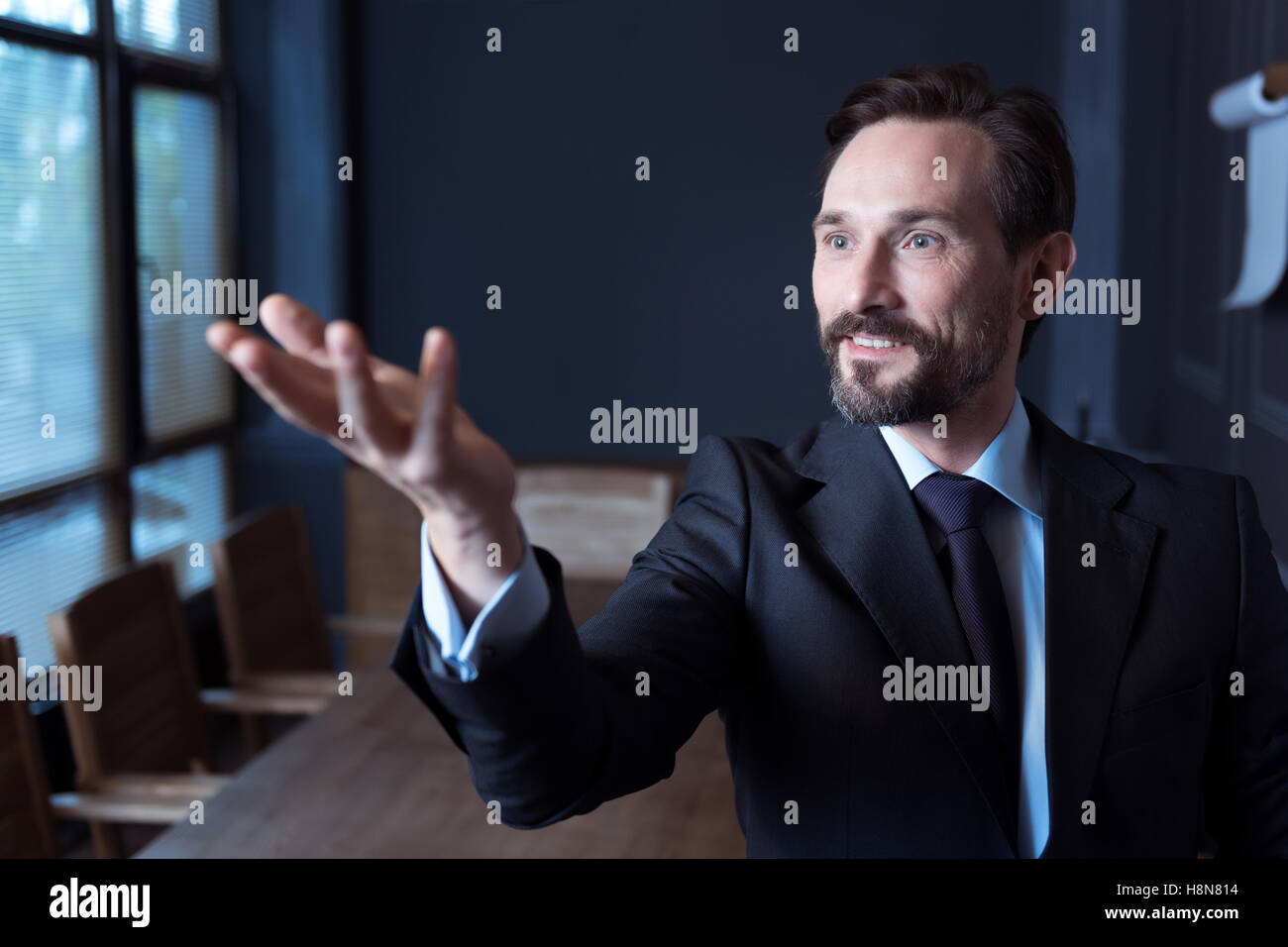Handsome joyful man looking at his hand Stock Photo - Alamy