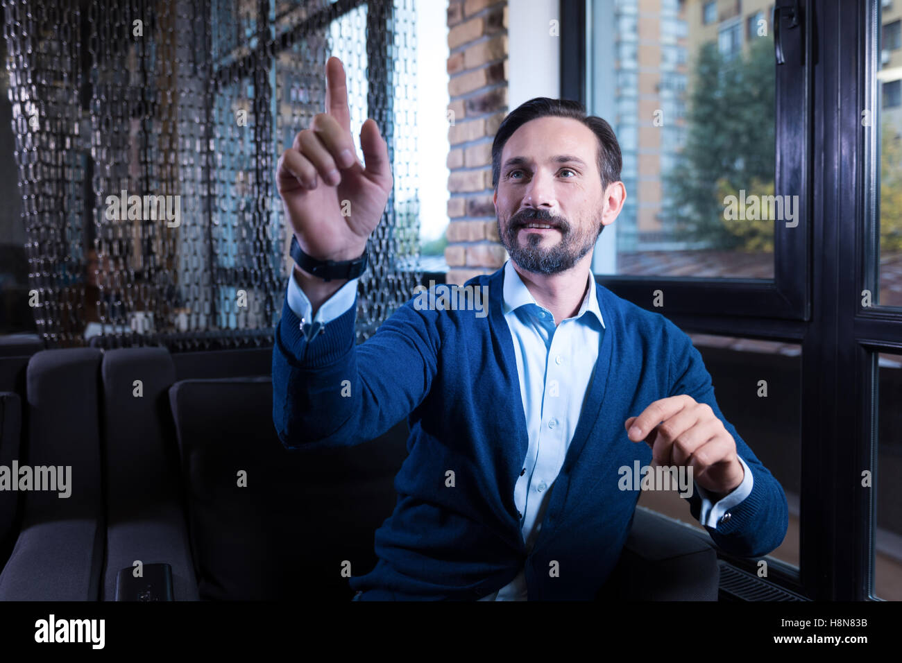 Happy pleasant man enjoying work with modern technology Stock Photo - Alamy