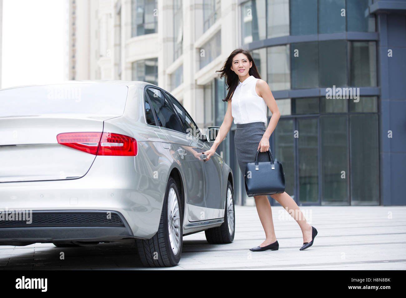 Young Chinese businesswoman and car Stock Photo - Alamy