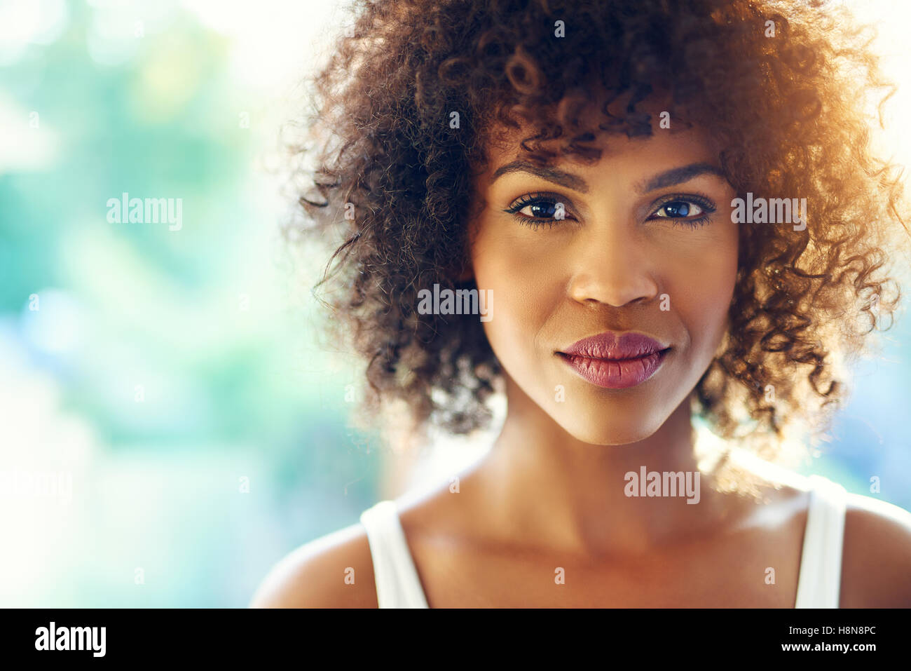 Close Up Portrait Of Beautiful Curly Girl Looking At Camera Emotionless