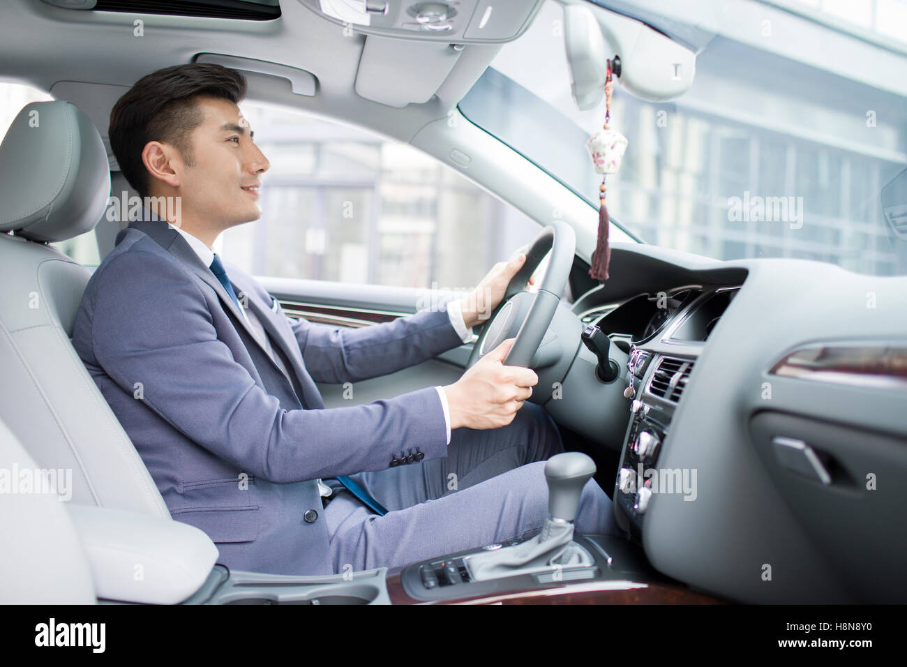 Confident Chinese businessman driving car Stock Photo - Alamy