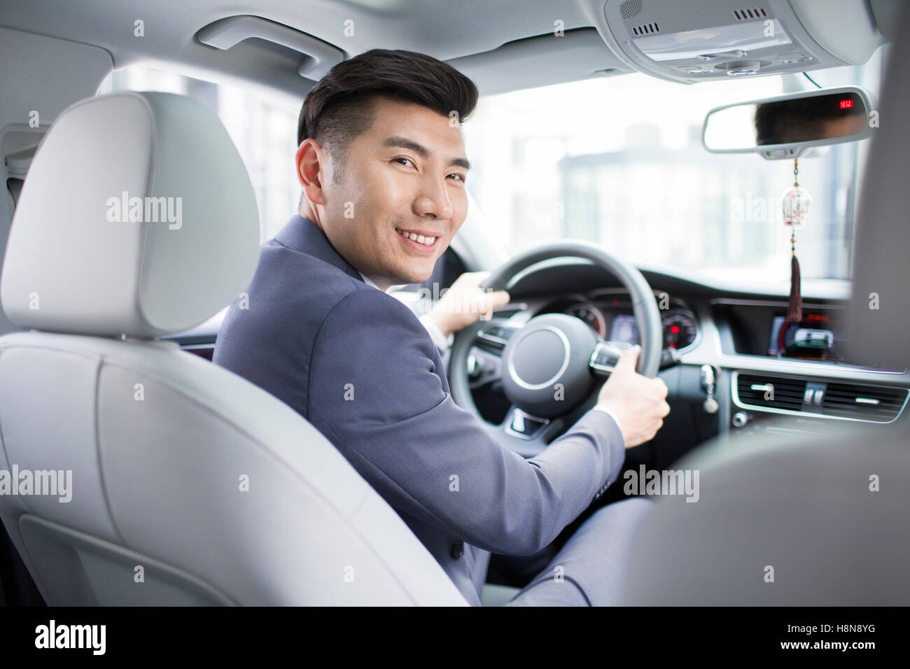 Confident Chinese businessman driving car Stock Photo - Alamy