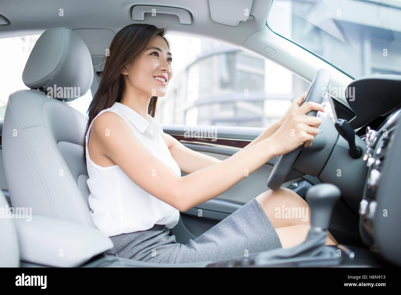Confident Chinese businesswoman driving car Stock Photo - Alamy