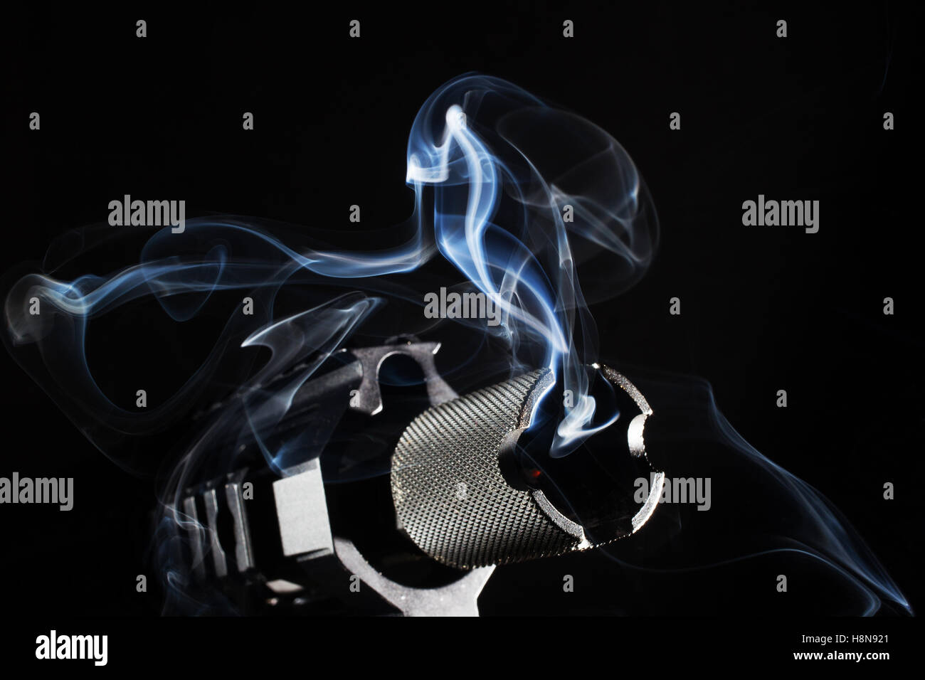 Smoke coming from the barrel of a hot assault rifle Stock Photo - Alamy