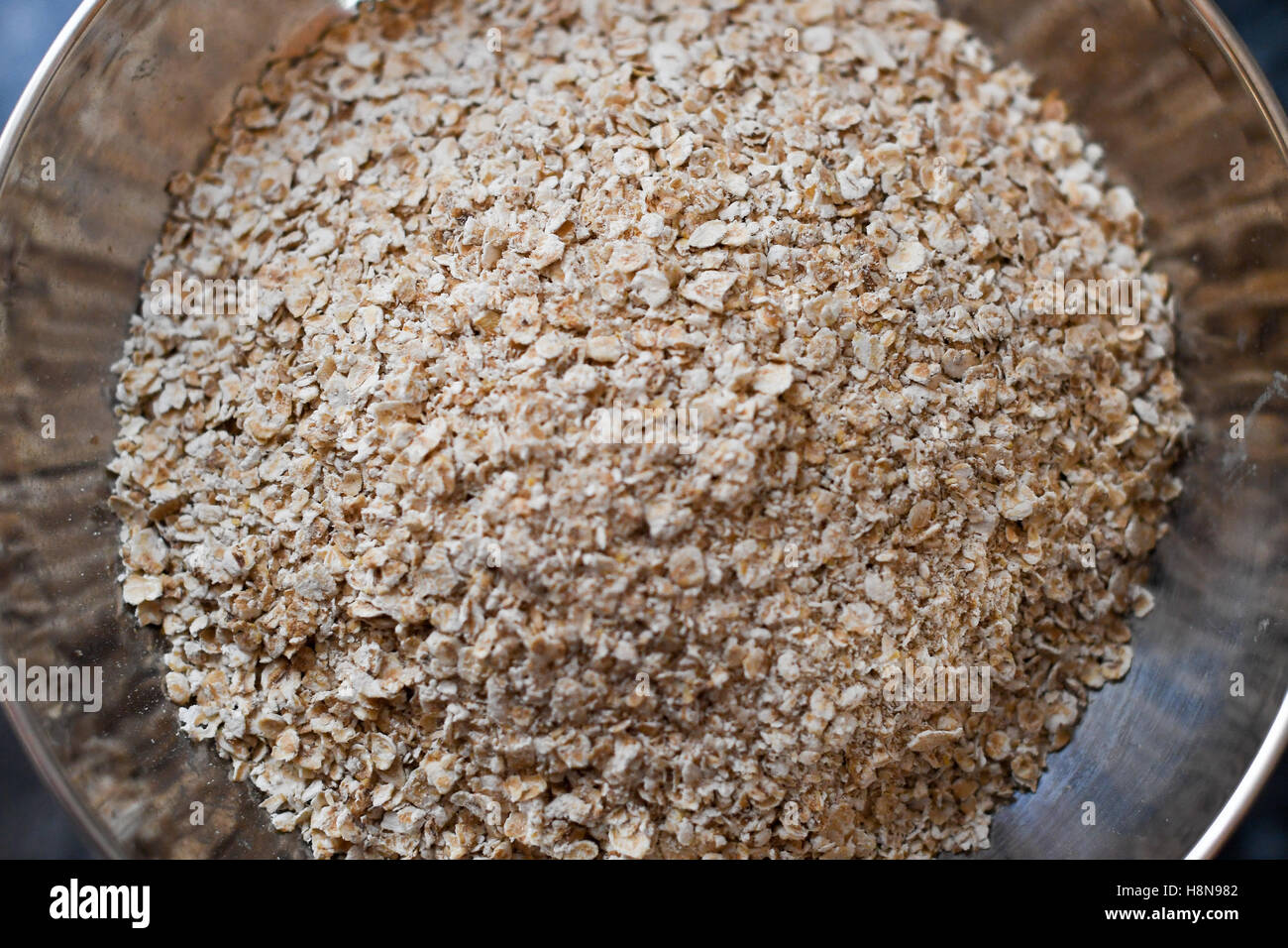 Porridge oats dry uncooked in a silver weighing dish Stock Photo - Alamy