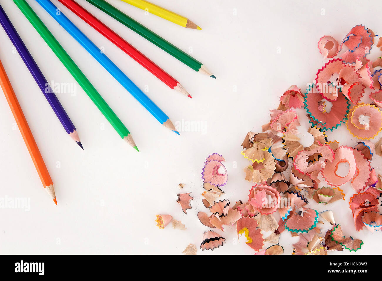 Multicolor pencils and shavings on white background with copy space ...